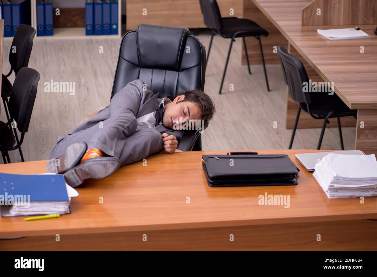 Young employee sleeping at workplace Stock Photo - Alamy