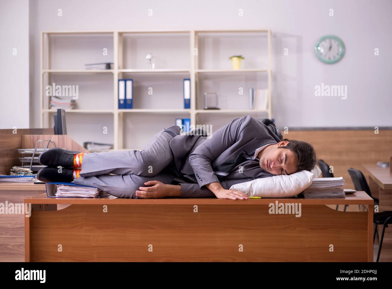 Young employee sleeping at workplace Stock Photo - Alamy