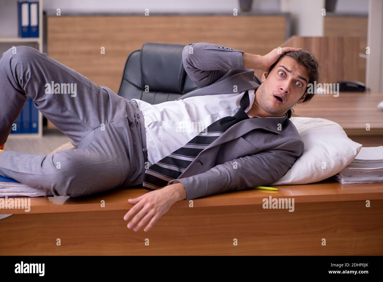 Young employee sleeping at workplace Stock Photo - Alamy