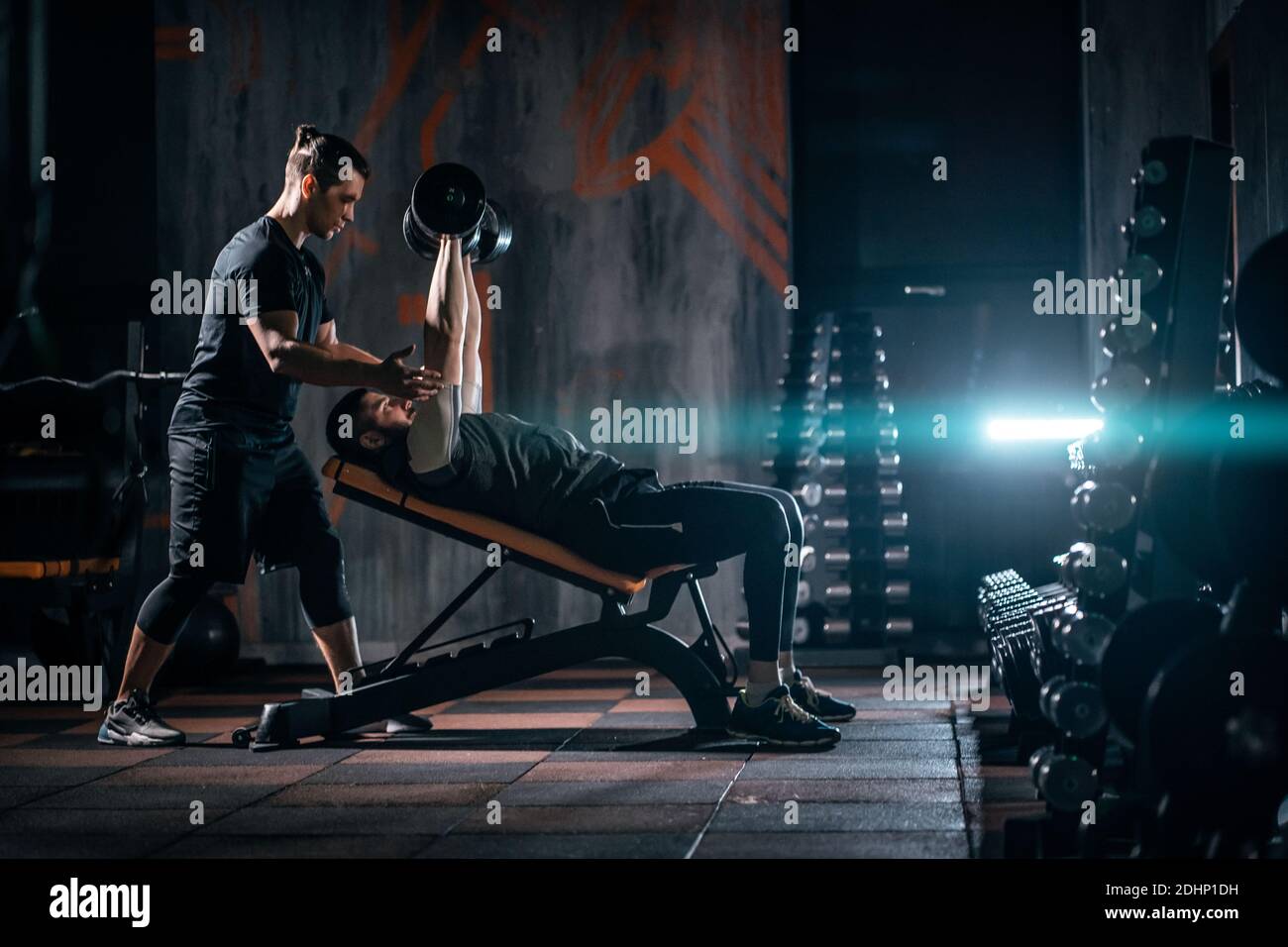 young man has workout with personal trainer in modern gym Stock Photo ...