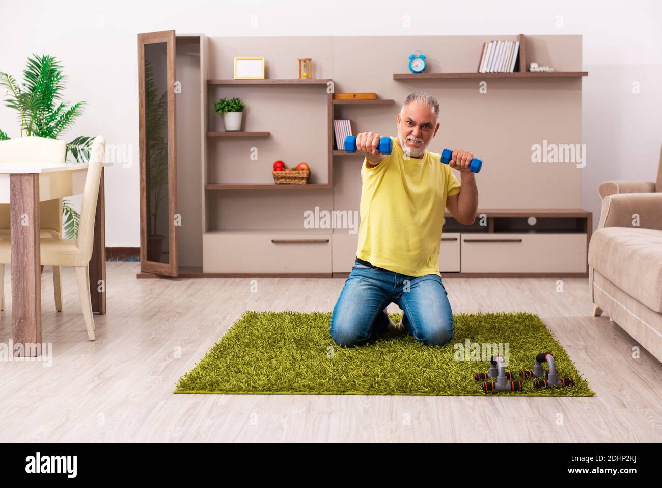 Old man doing sport exercises at home Stock Photo - Alamy