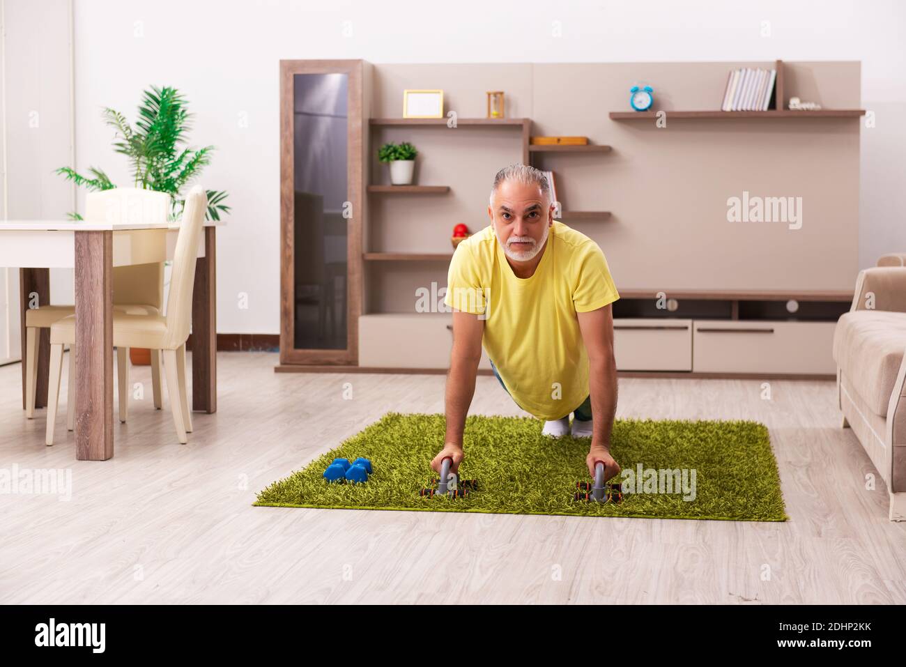 Old man doing sport exercises at home Stock Photo - Alamy