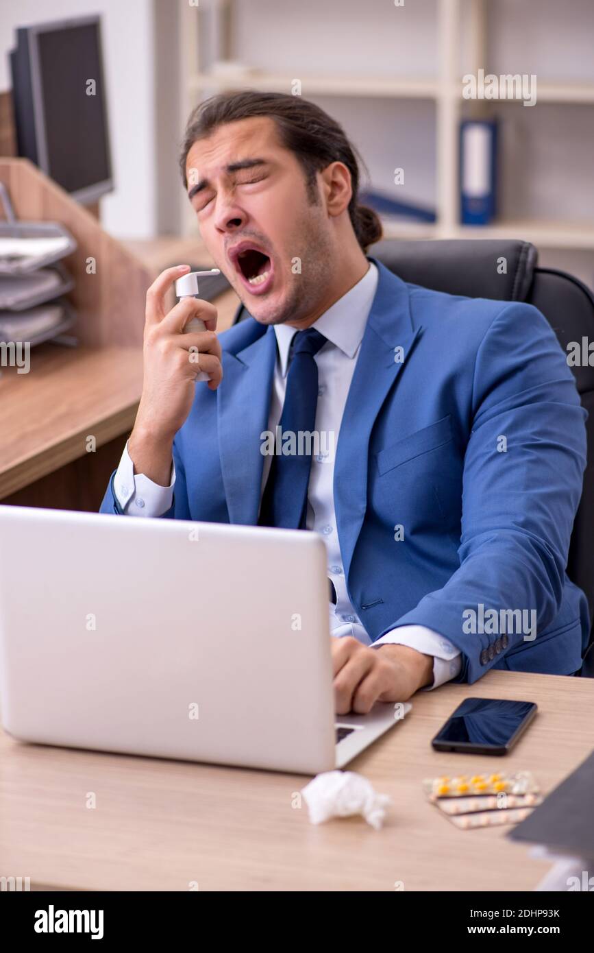 Sick businessman employee suffering at workplace Stock Photo - Alamy