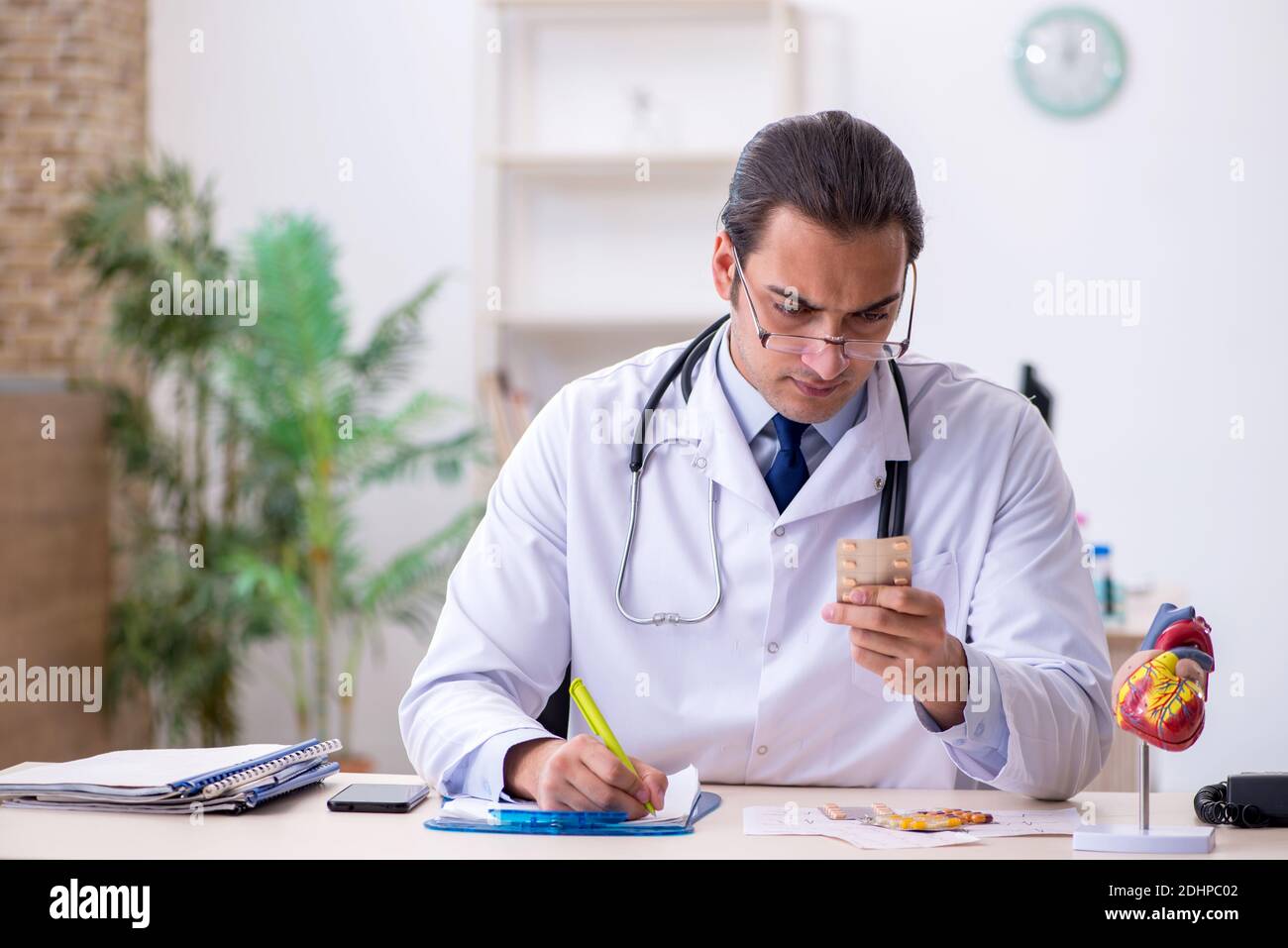 Young doctor cardiologist working in the clinic Stock Photo - Alamy