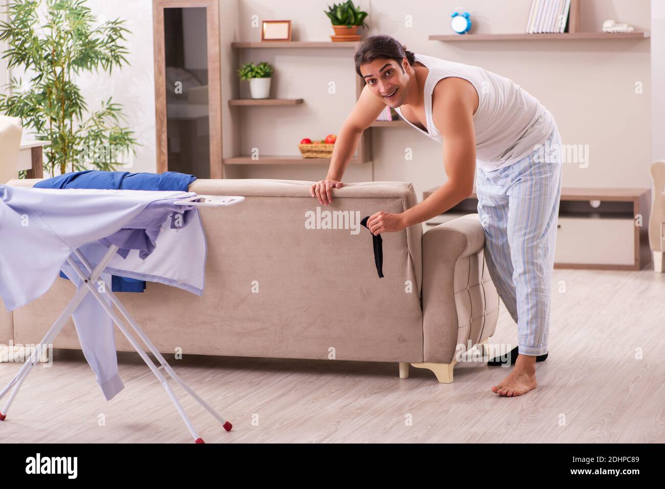 Young employee getting up late at home Stock Photo - Alamy