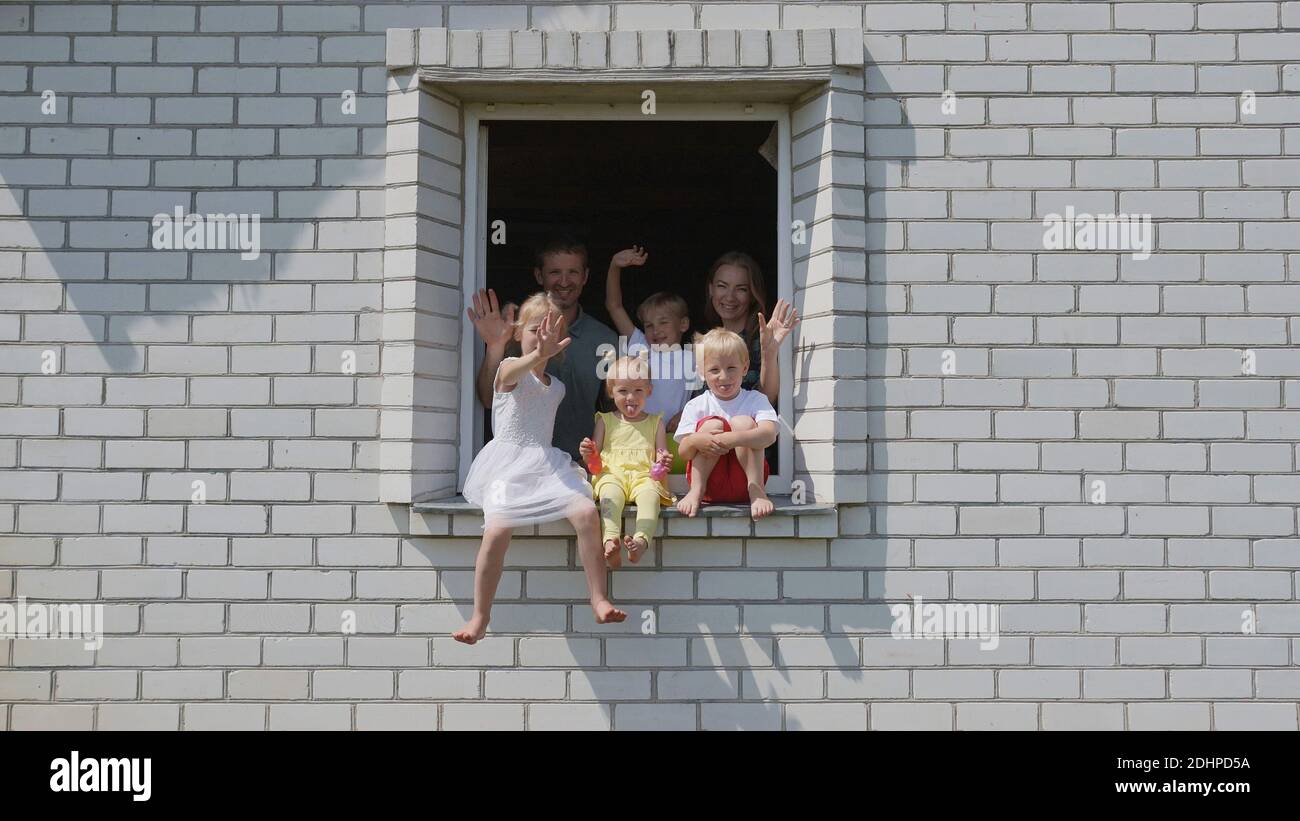 The concept of a large family. A friendly family waves their hands from ...