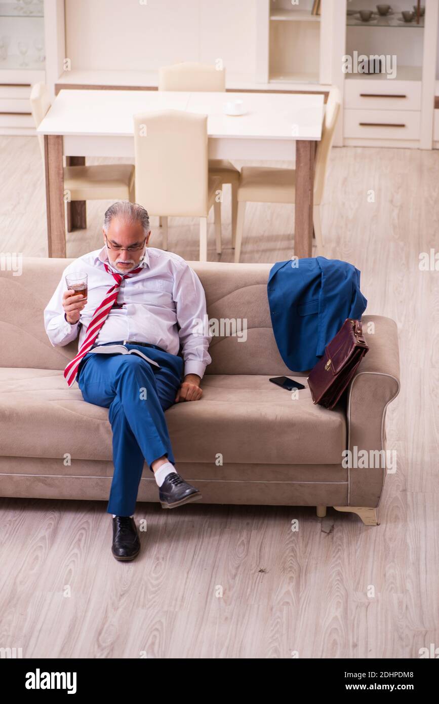 Senior male boss employee coming home from work Stock Photo - Alamy