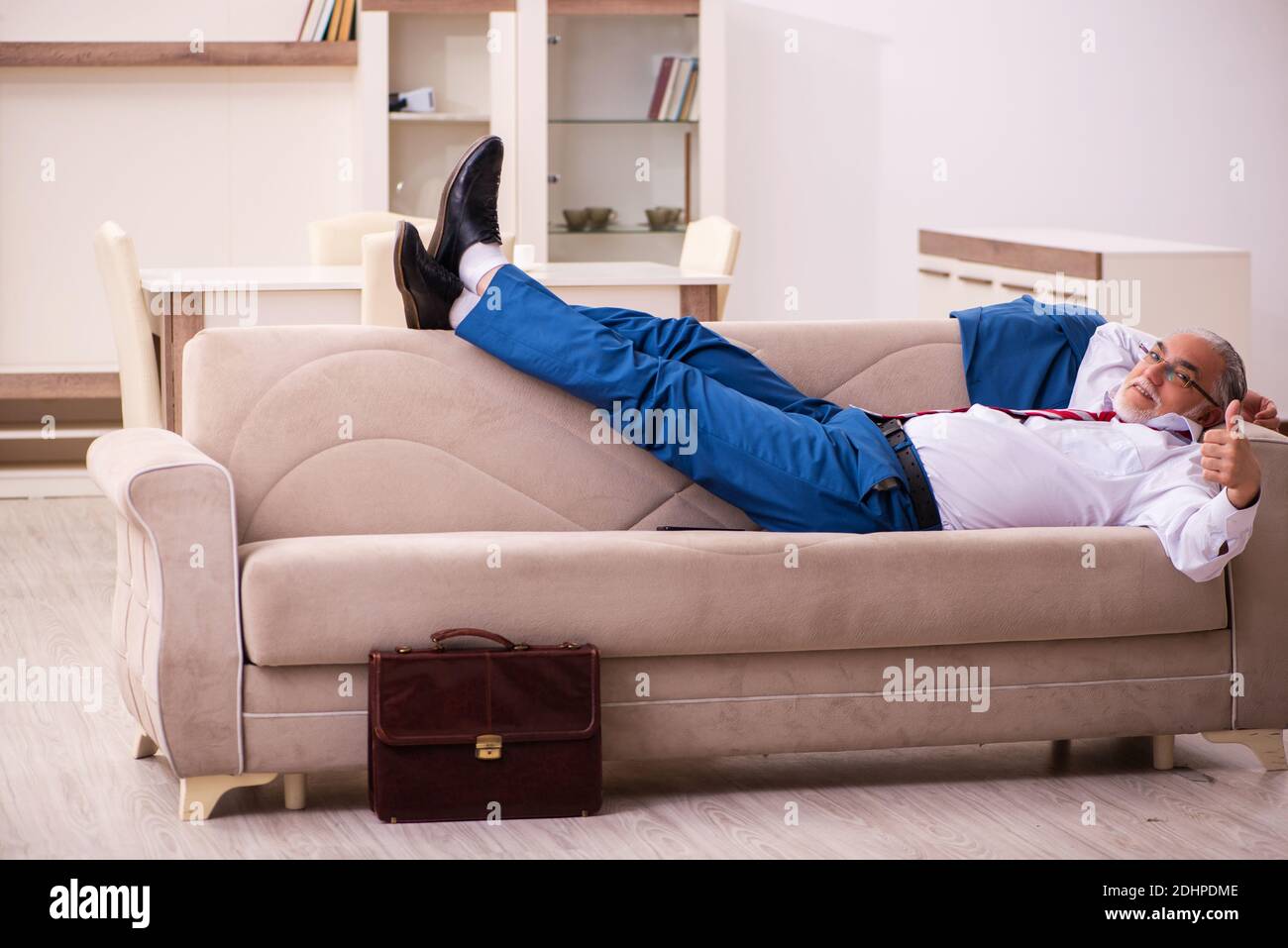 Senior male boss employee coming home from work Stock Photo - Alamy