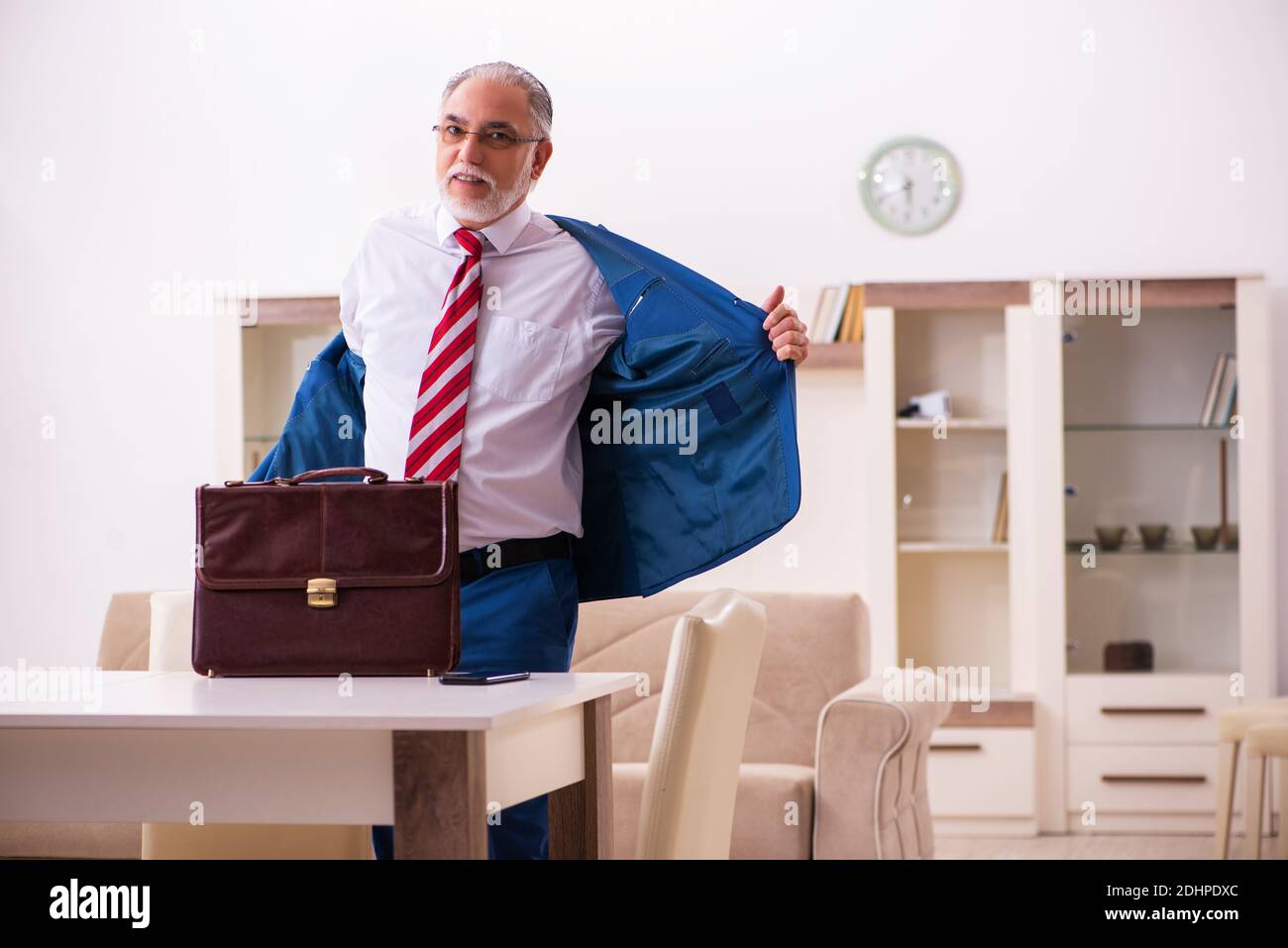Senior male boss employee coming home from work Stock Photo - Alamy