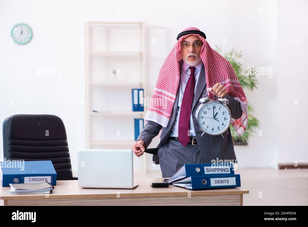 Old arab bookkeeper in time management concept Stock Photo - Alamy
