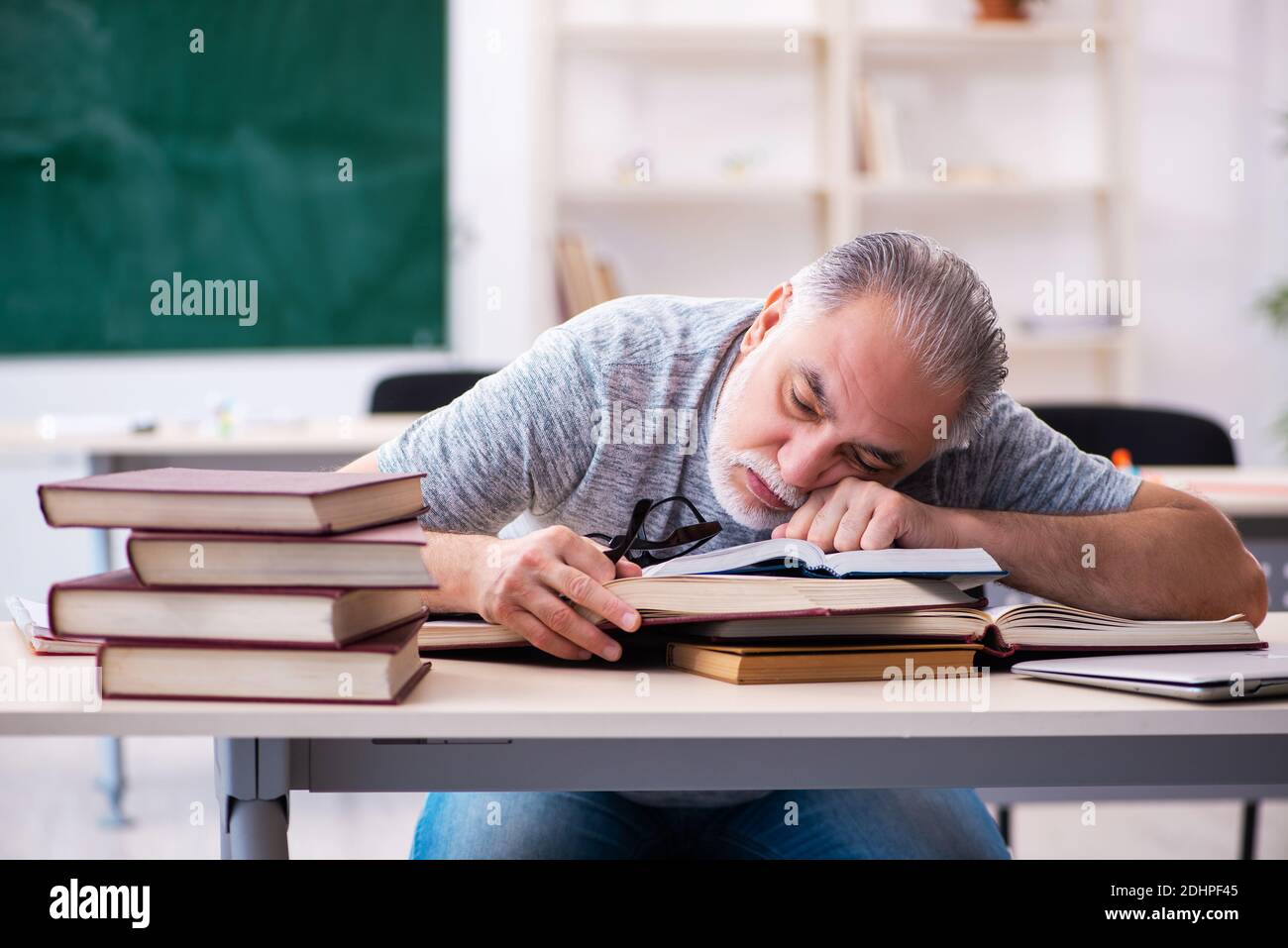 Senior male student being exhausted during exam preparation Stock Photo ...