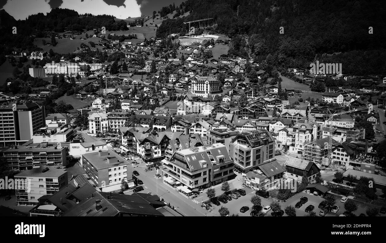 Flight over the city of Engelberg in Switzerland in black and white ...