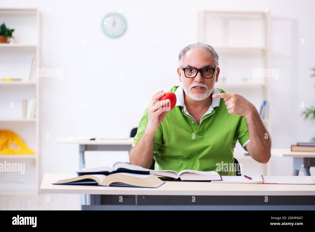 Male teacher eating apple hi-res stock photography and images - Alamy