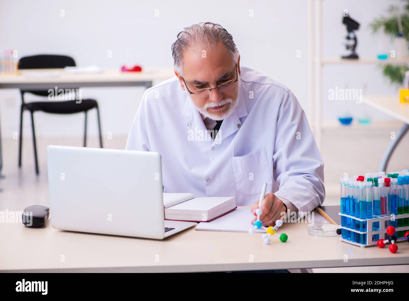 Chemist taking liquid sample examining hi-res stock photography and ...