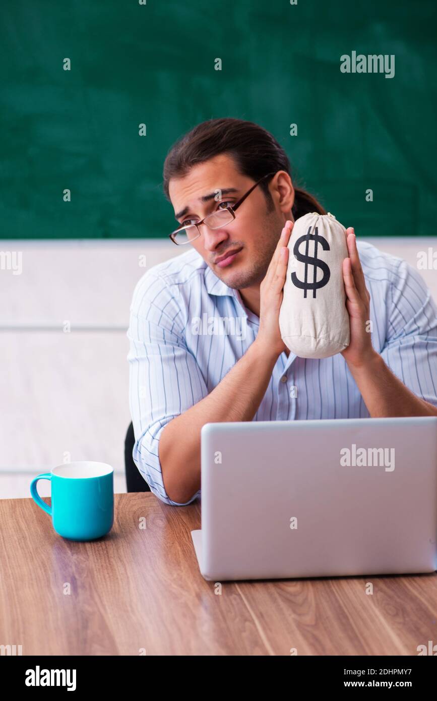 Young teacher in remuneration concept Stock Photo - Alamy