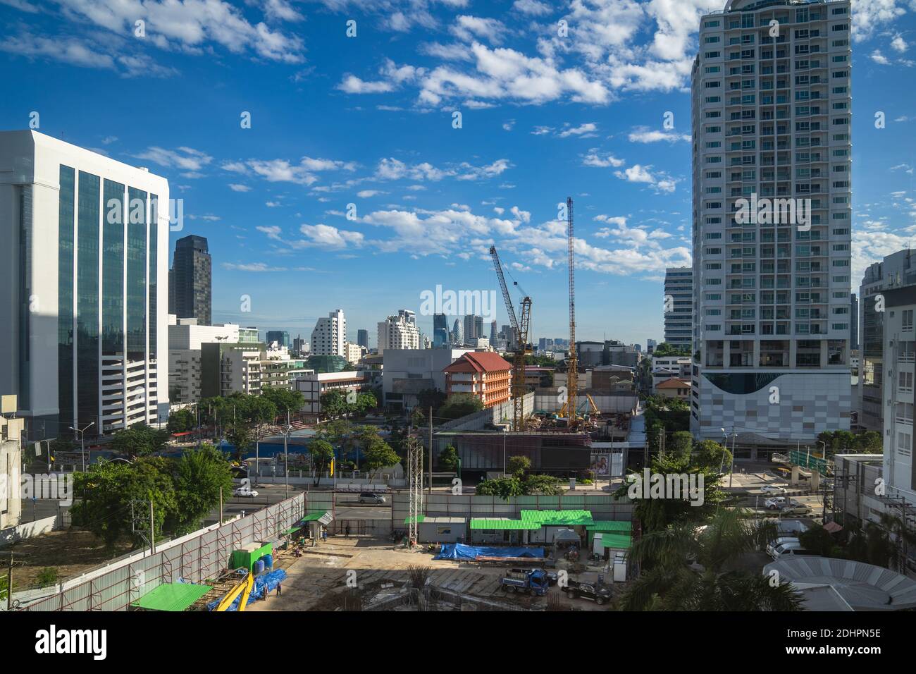 Under construction in Midtown of city with High rise building around ...