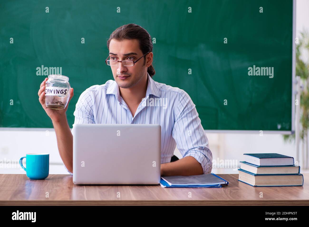 Young teacher in remuneration concept Stock Photo - Alamy
