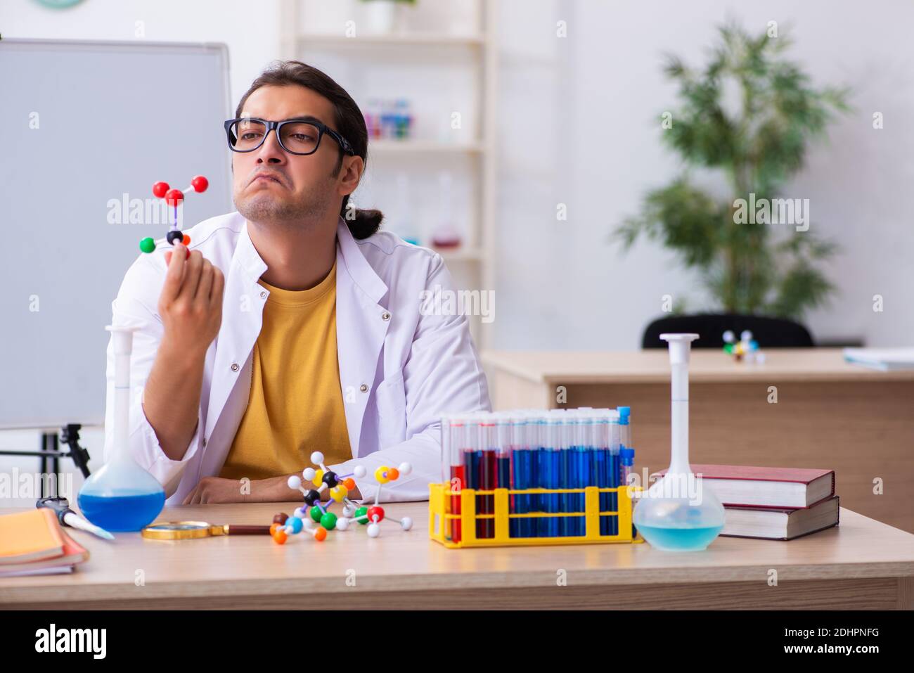 Young chemist studying molecular model in the classroom Stock Photo - Alamy