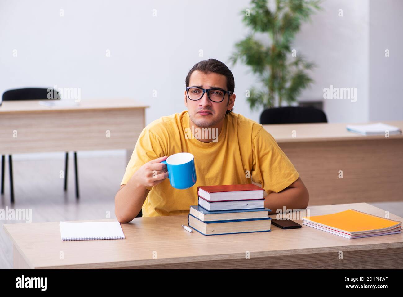 Young student having break during exam preparation Stock Photo - Alamy