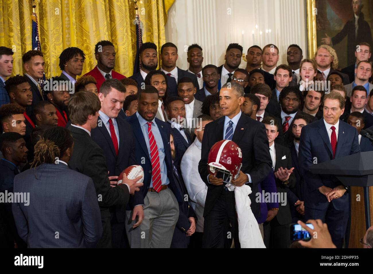 U.S. President Barack Obama (right) is presented with an Alabama ...