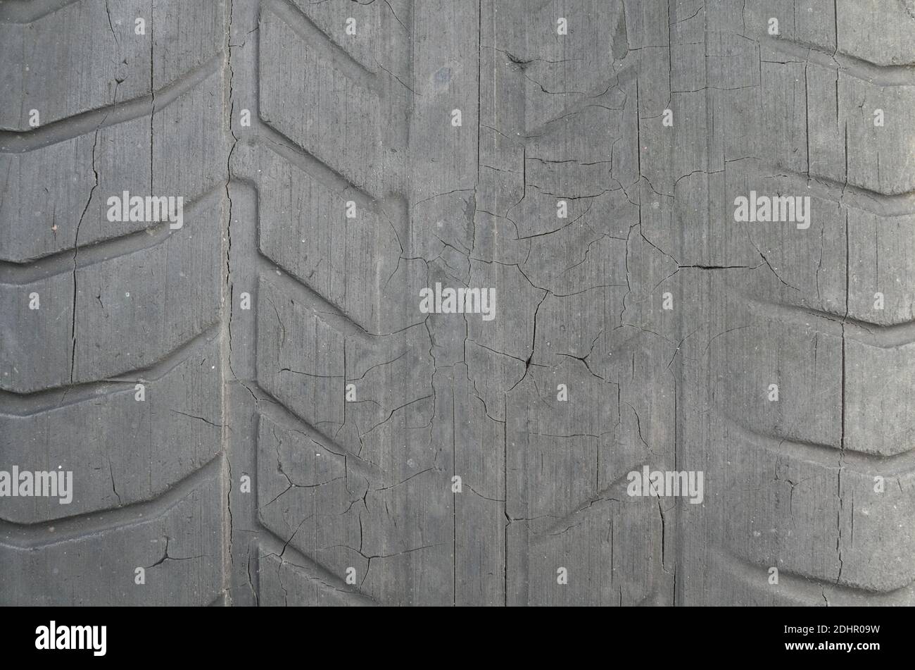 Old black tire with worn tread and cracks, worn old car tire tread, old ...