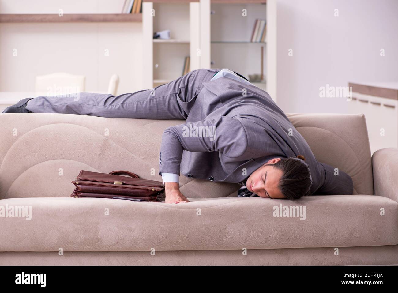 Tired businessman coming home after working day Stock Photo - Alamy