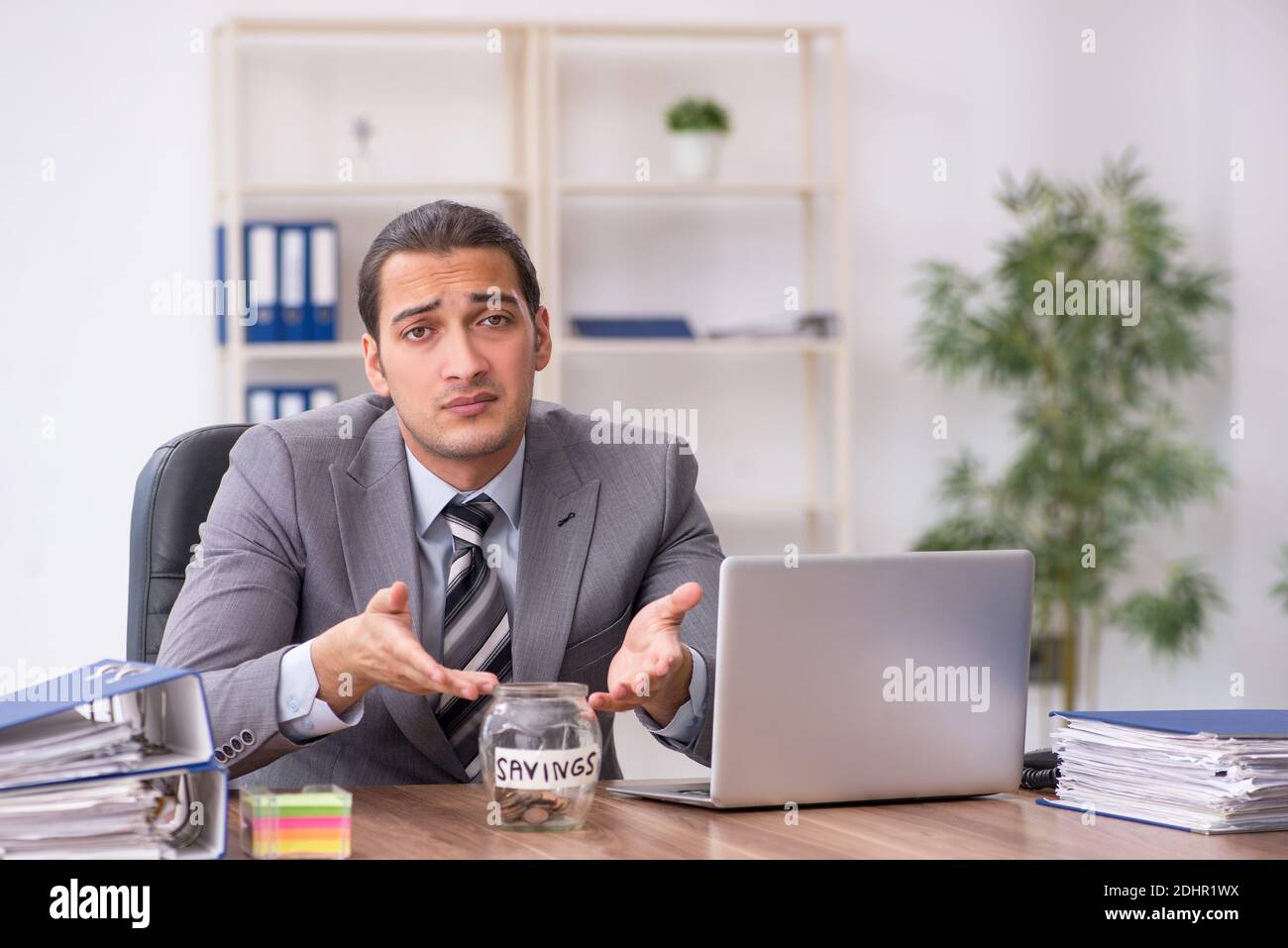 Young employee in pension concept at workplace Stock Photo - Alamy