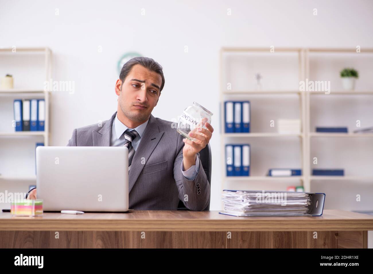 Young employee in pension concept at workplace Stock Photo - Alamy