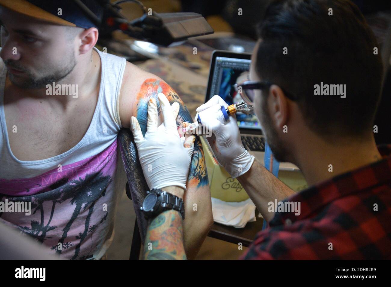 A tattoo artist works on the Mondial du tatouage (World Tattoo ...