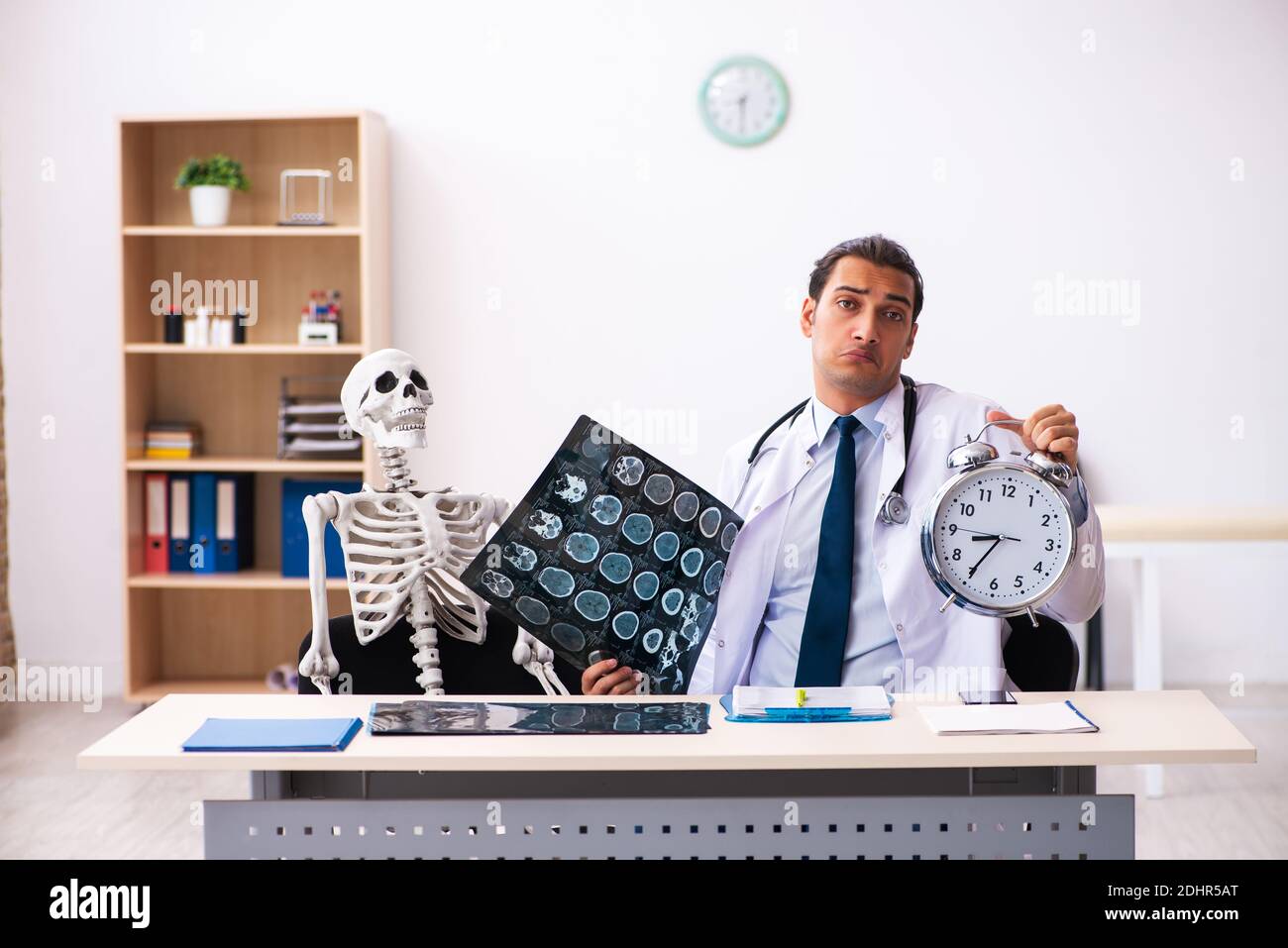 Young doctor radiologist and skeleton patient in the clinic Stock Photo ...