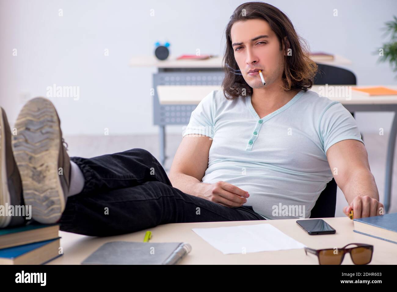 Male student smoking cigarettes in the classroom Stock Photo - Alamy