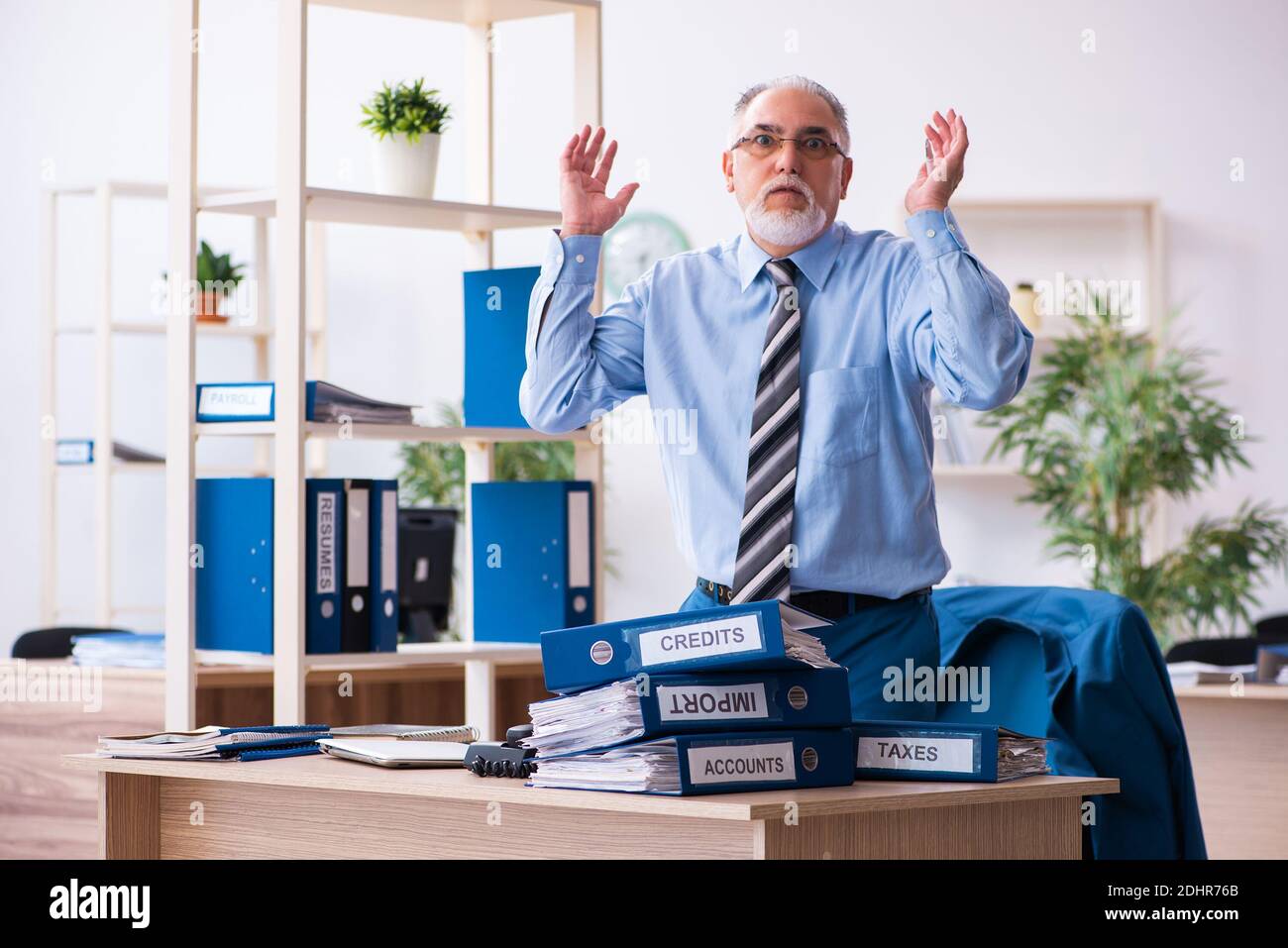 Senior male bookkeeper unhappy with excessive work at workplace Stock ...