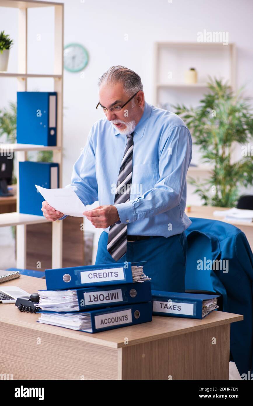 Senior male bookkeeper unhappy with excessive work at workplace Stock ...