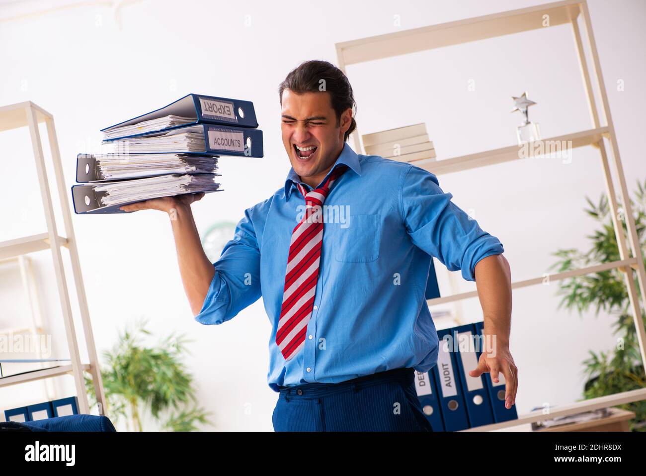 Young businessman doing sport exercises at workplace Stock Photo - Alamy