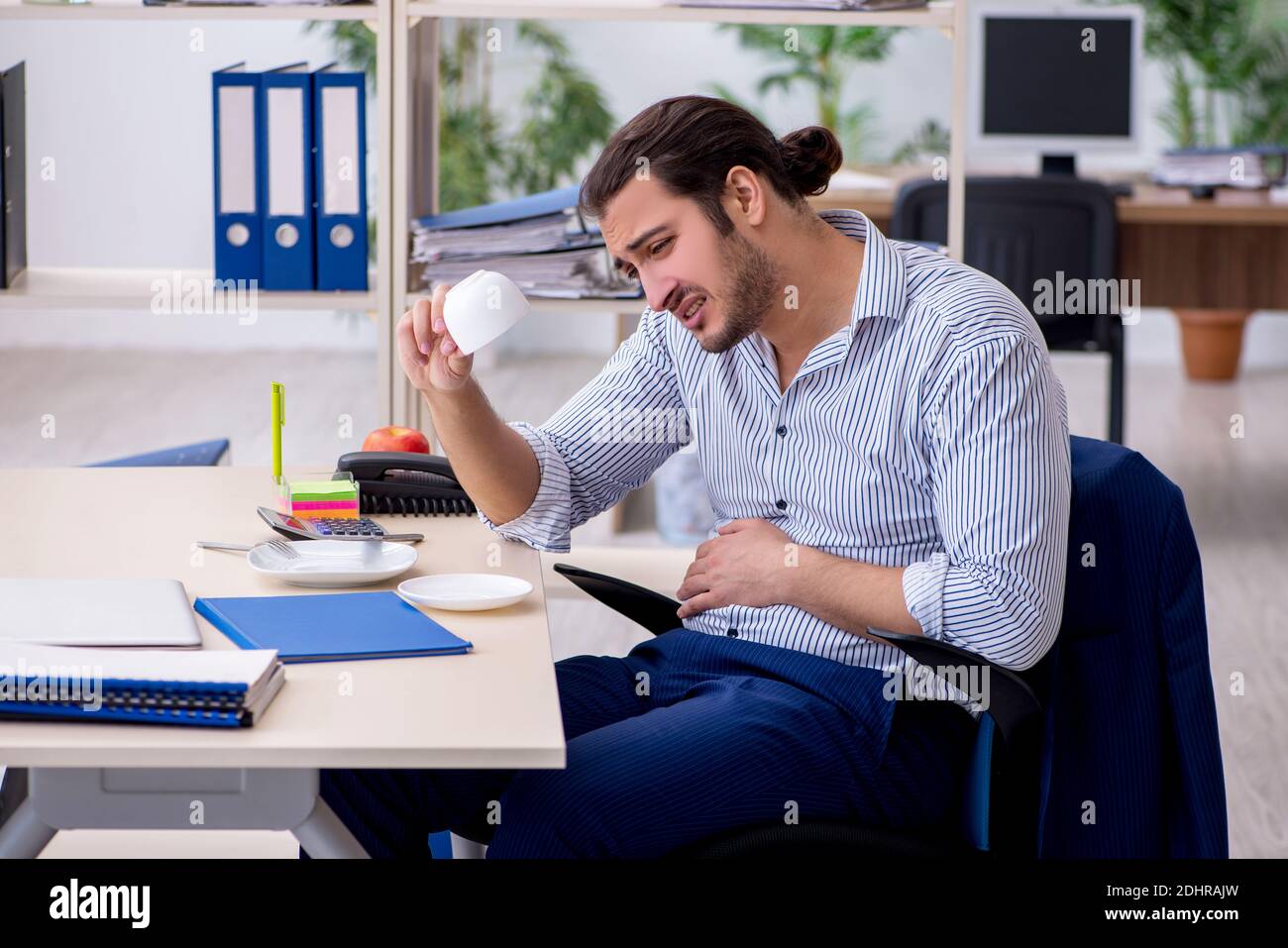 Hungry employee waiting for food at workplace Stock Photo - Alamy