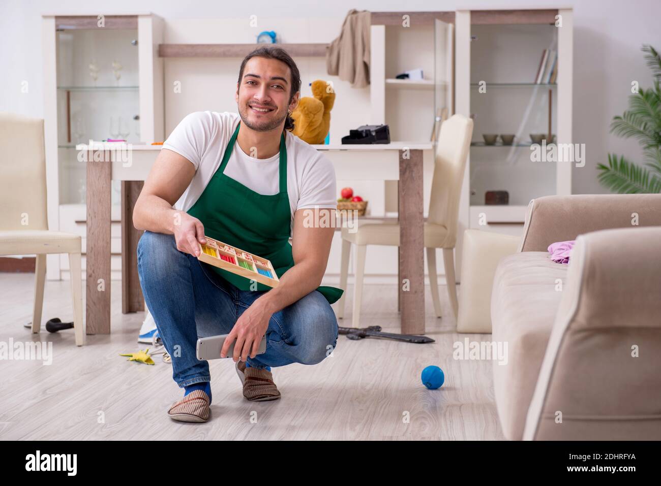 Young contractor cleaning the flat after kids' party Stock Photo - Alamy