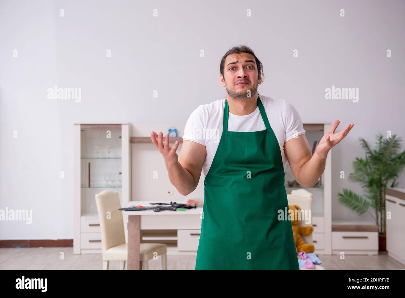 Young contractor cleaning the flat after kids' party Stock Photo - Alamy