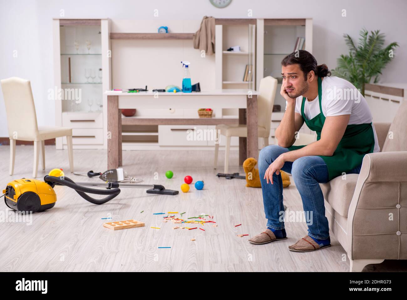 Young contractor cleaning the flat after kids' party Stock Photo - Alamy