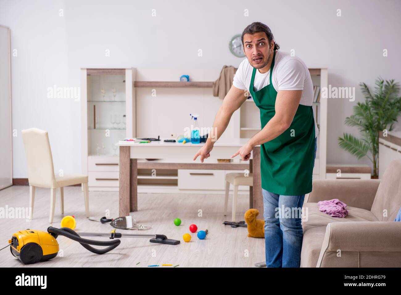 Young contractor cleaning the flat after kids' party Stock Photo - Alamy