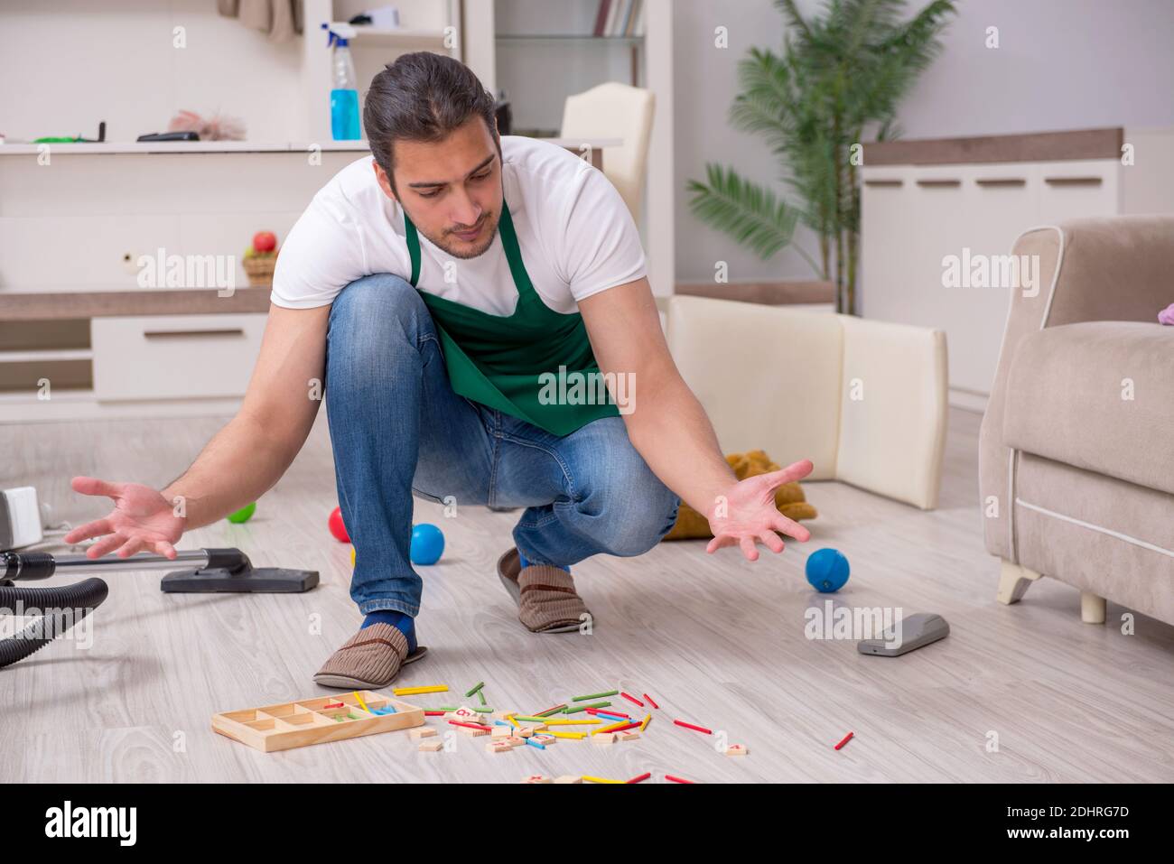 Young contractor cleaning the flat after kids' party Stock Photo - Alamy