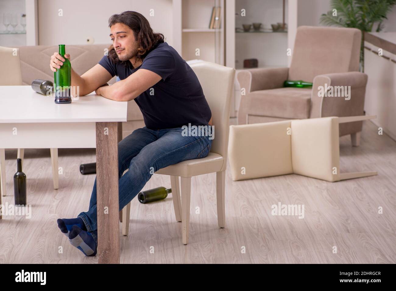 Young man drinking alcohol at home Stock Photo - Alamy