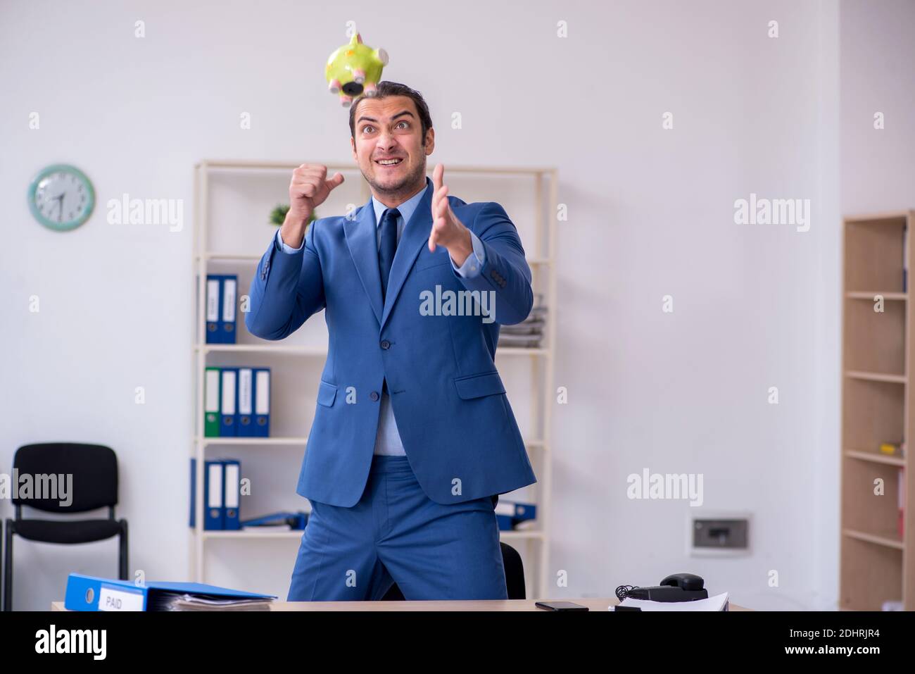 Young employee in budget planning concept Stock Photo - Alamy
