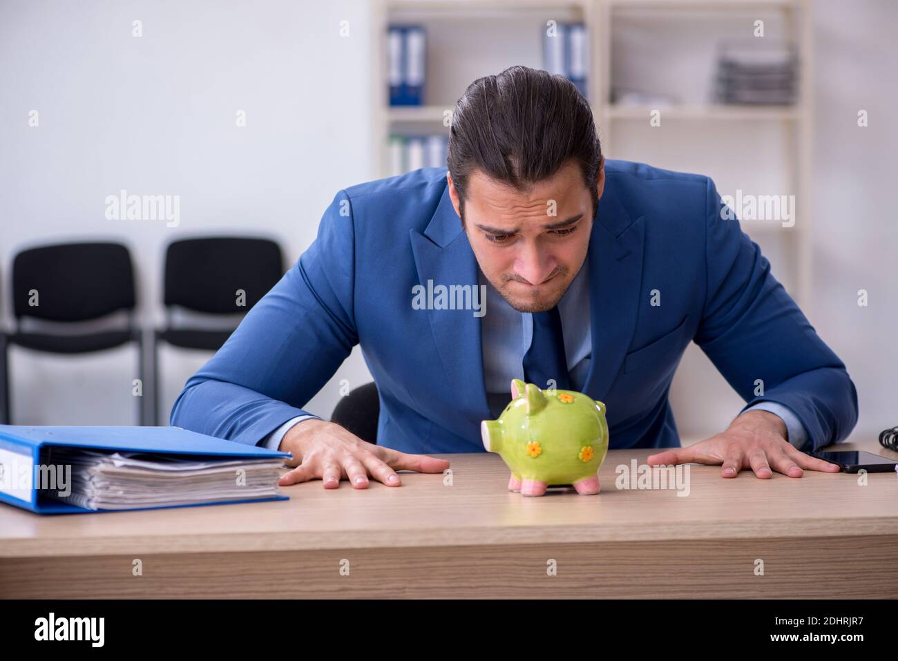 Young employee in budget planning concept Stock Photo - Alamy