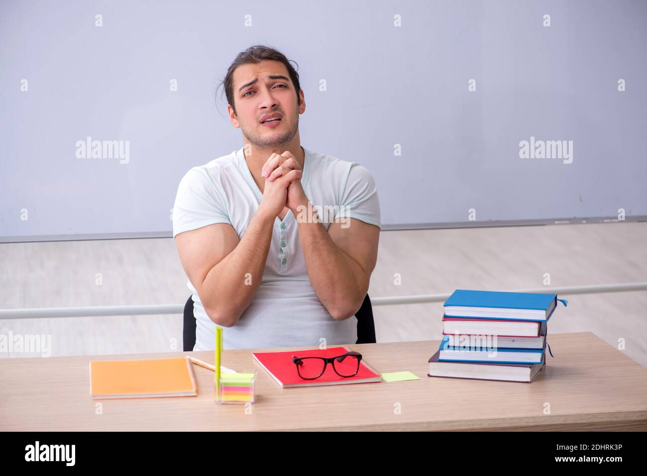 Young teacher student sitting in the classroom Stock Photo - Alamy