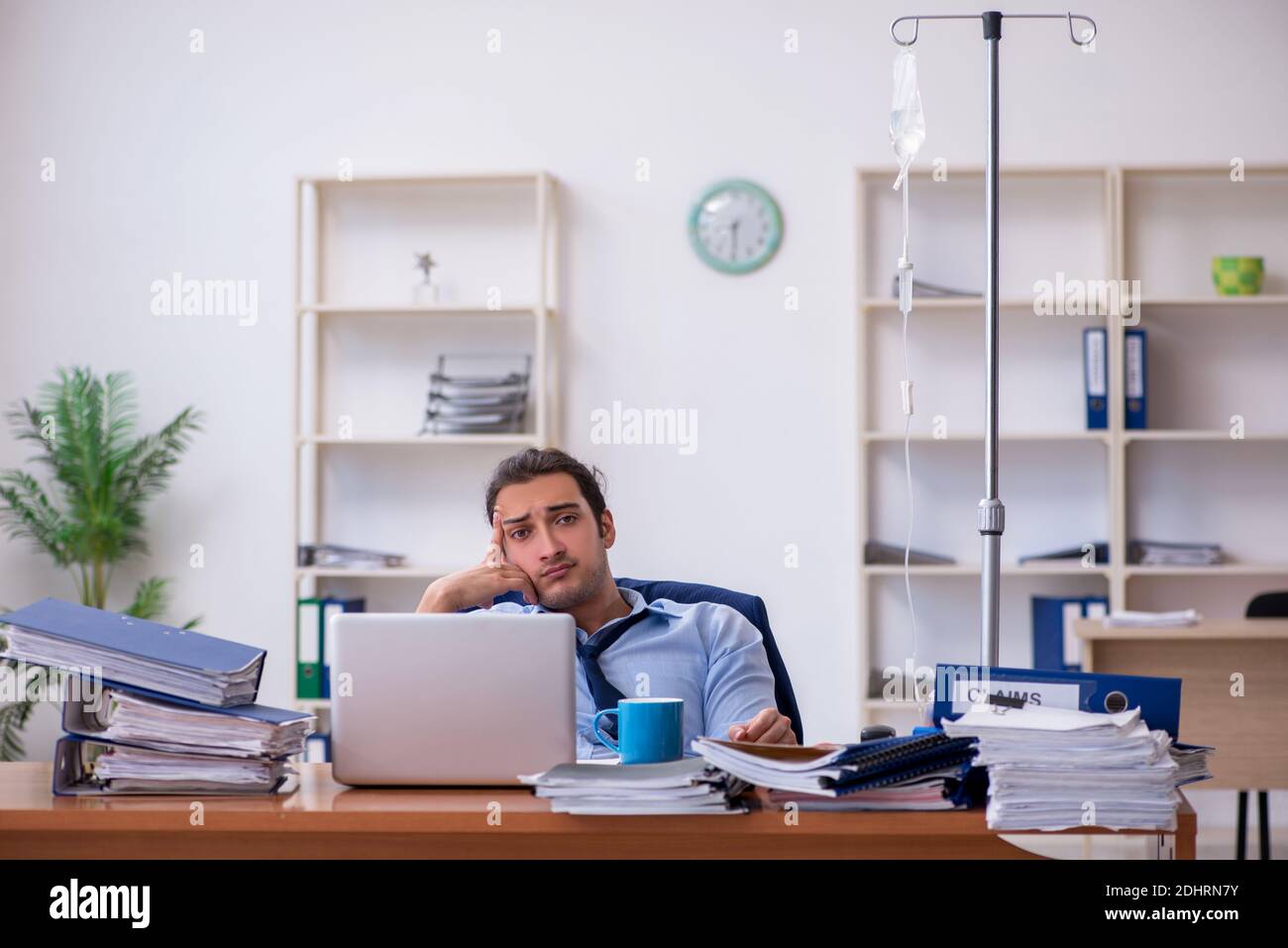 Male employee suffering at workplace Stock Photo - Alamy