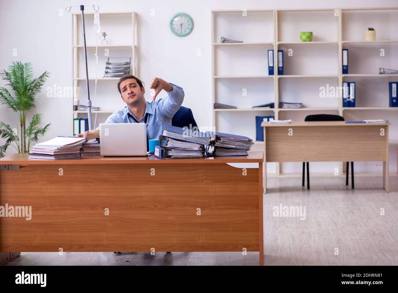 Male employee suffering at workplace Stock Photo - Alamy