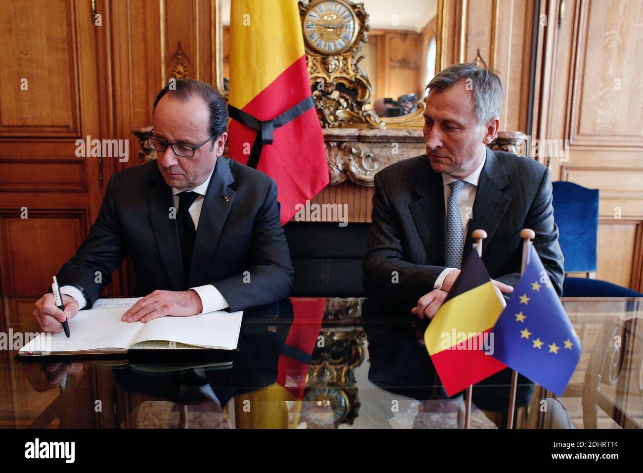 France's President Francois Hollande (L) signs the condolence book as ...