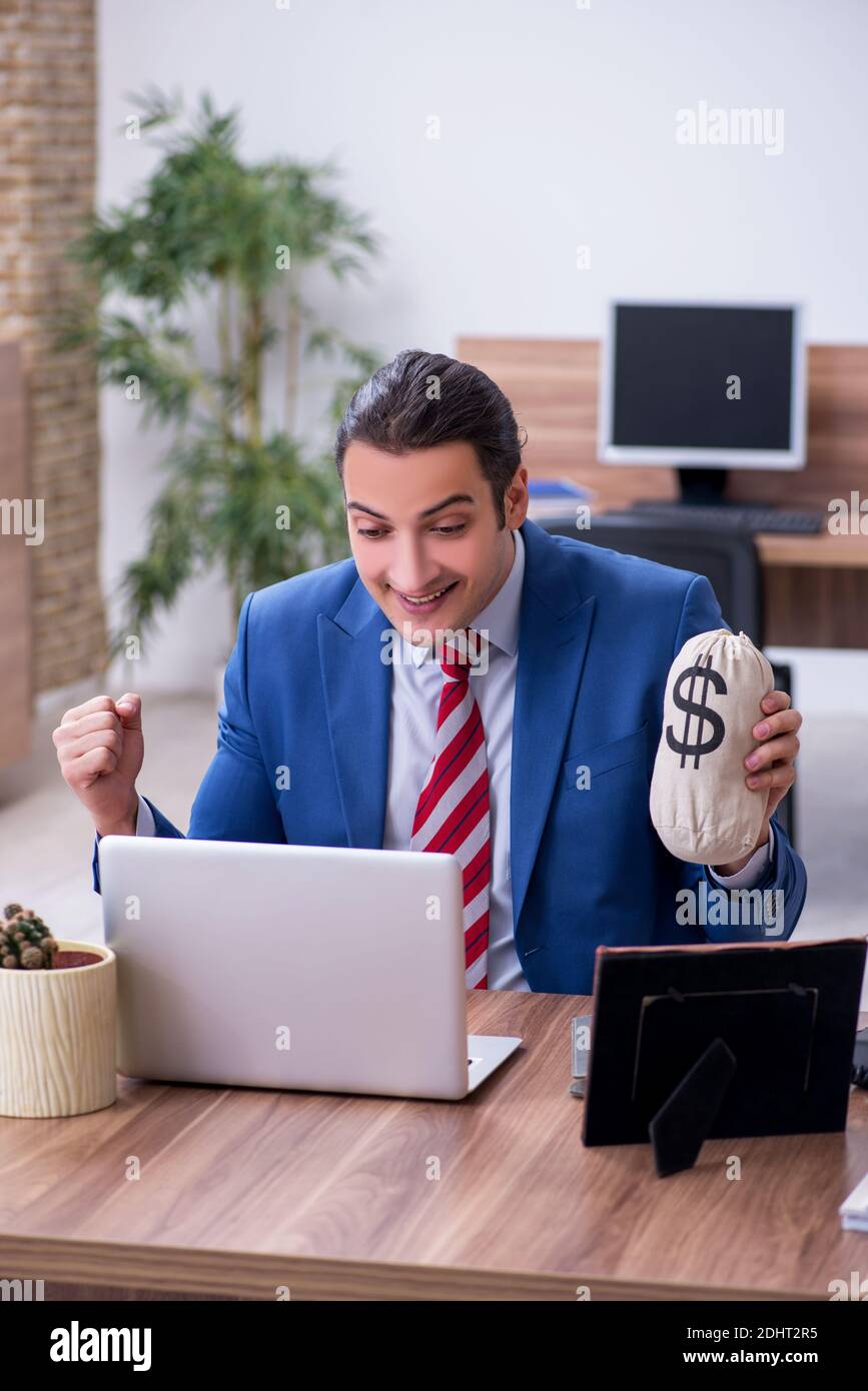 Young employee in remuneration concept Stock Photo - Alamy