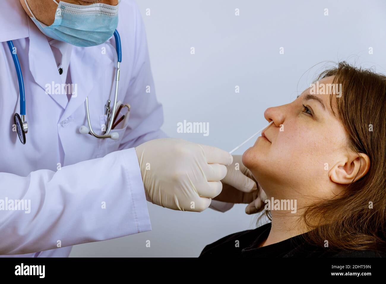 Doctor worker taking a swab a coronavirus COVID-19 test a nasal sample ...
