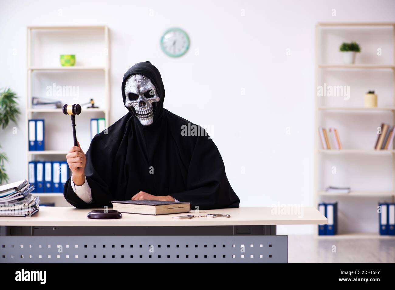 Devil judge working in the courthouse Stock Photo - Alamy